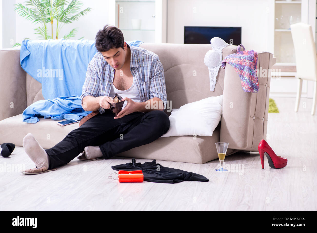 Man with mess at home after house party Stock Photo - Alamy