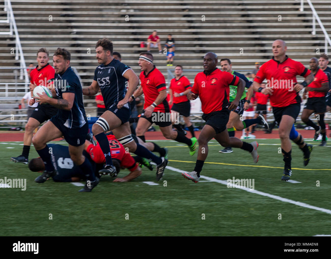 A Royal Sailor assigned the Royal Navy Rugby Team runs with the ball ...