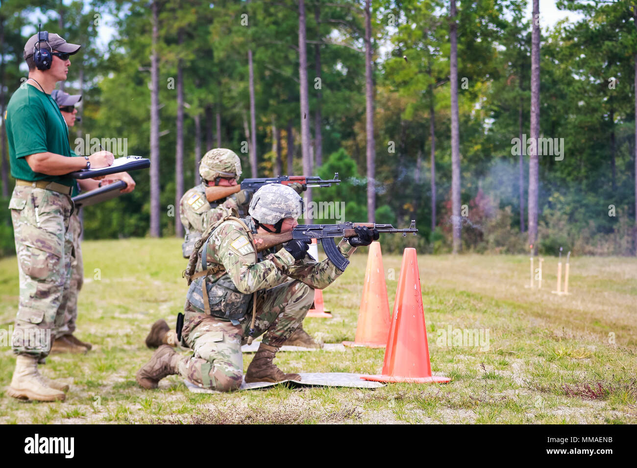 Rounds eject from Ak-47 assault rifles as U.S. Army Sgt. Kevin Beuse ...