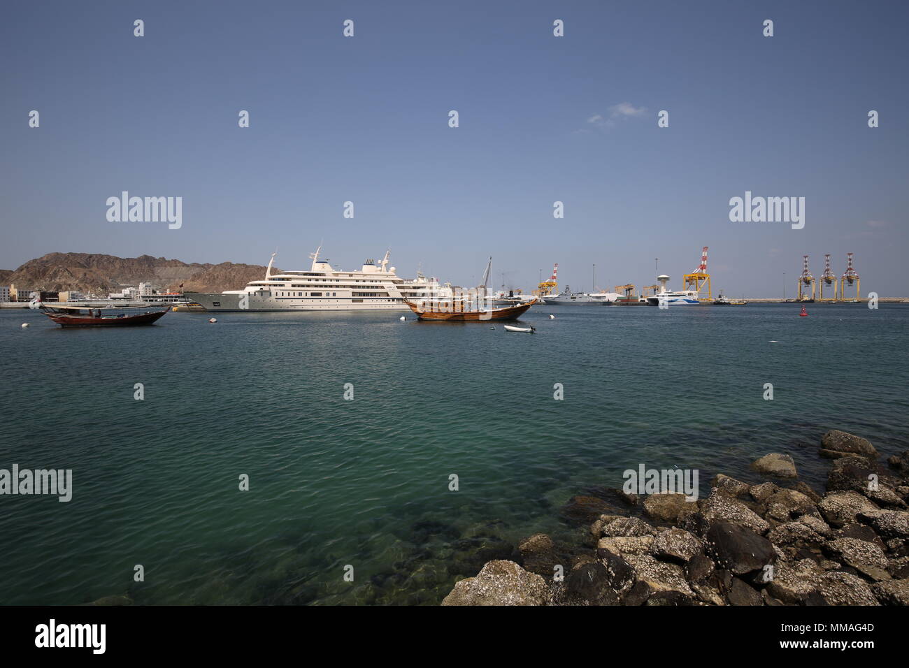 A traditional dhow boat and yatch of Sultan Qaboos at Mutrah Harbour ...