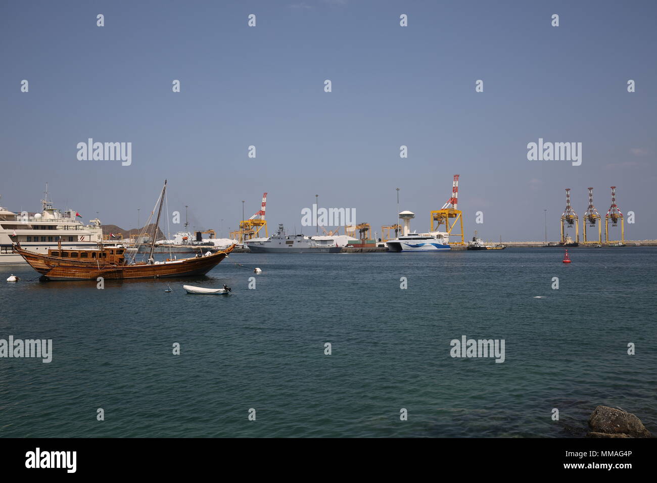 A traditional dhow boat and yatch of Sultan Qaboos at Mutrah Harbour ...
