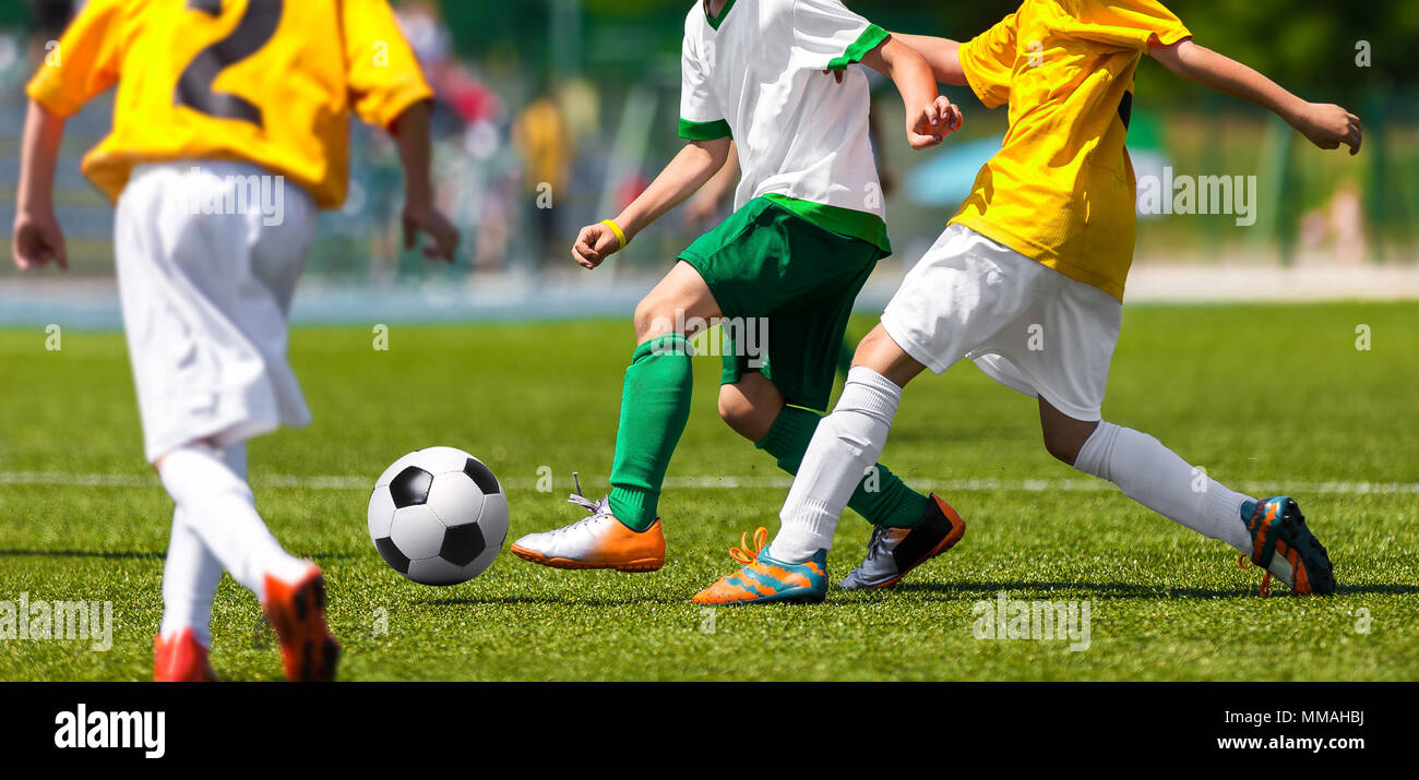 Young boys playing football soccer game. Running players in white and ...