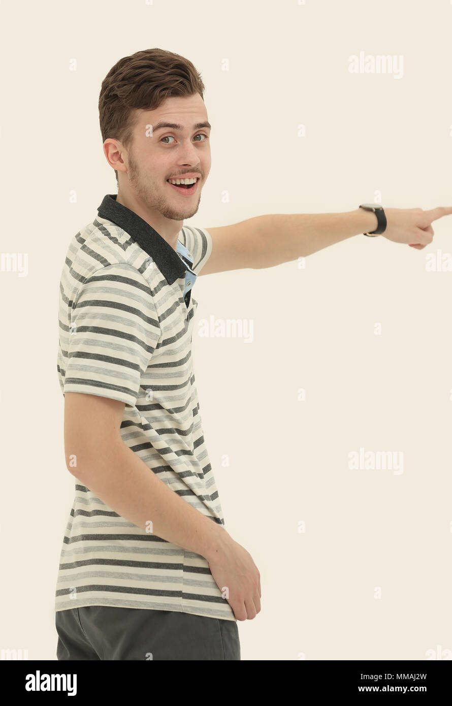 side view.modern young man pointing forward and looking at the camera ...