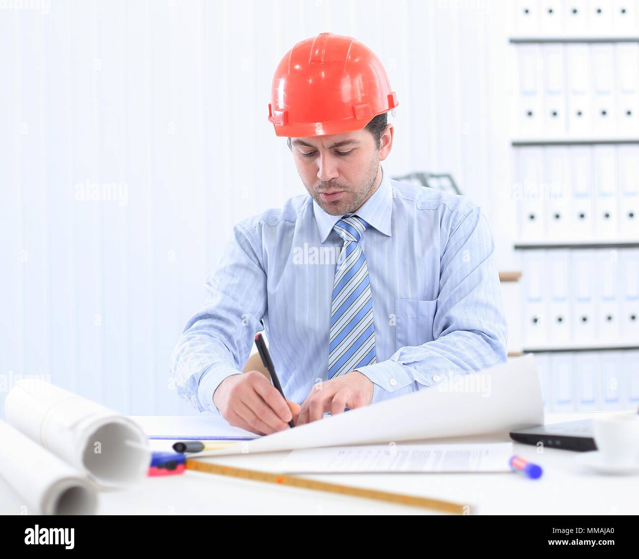 Architect looking working in office at desk Stock Photo - Alamy