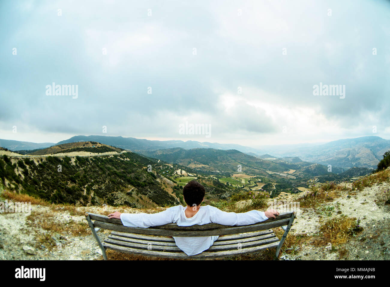 Man sitting on bench in cyprus mountains Stock Photo - Alamy