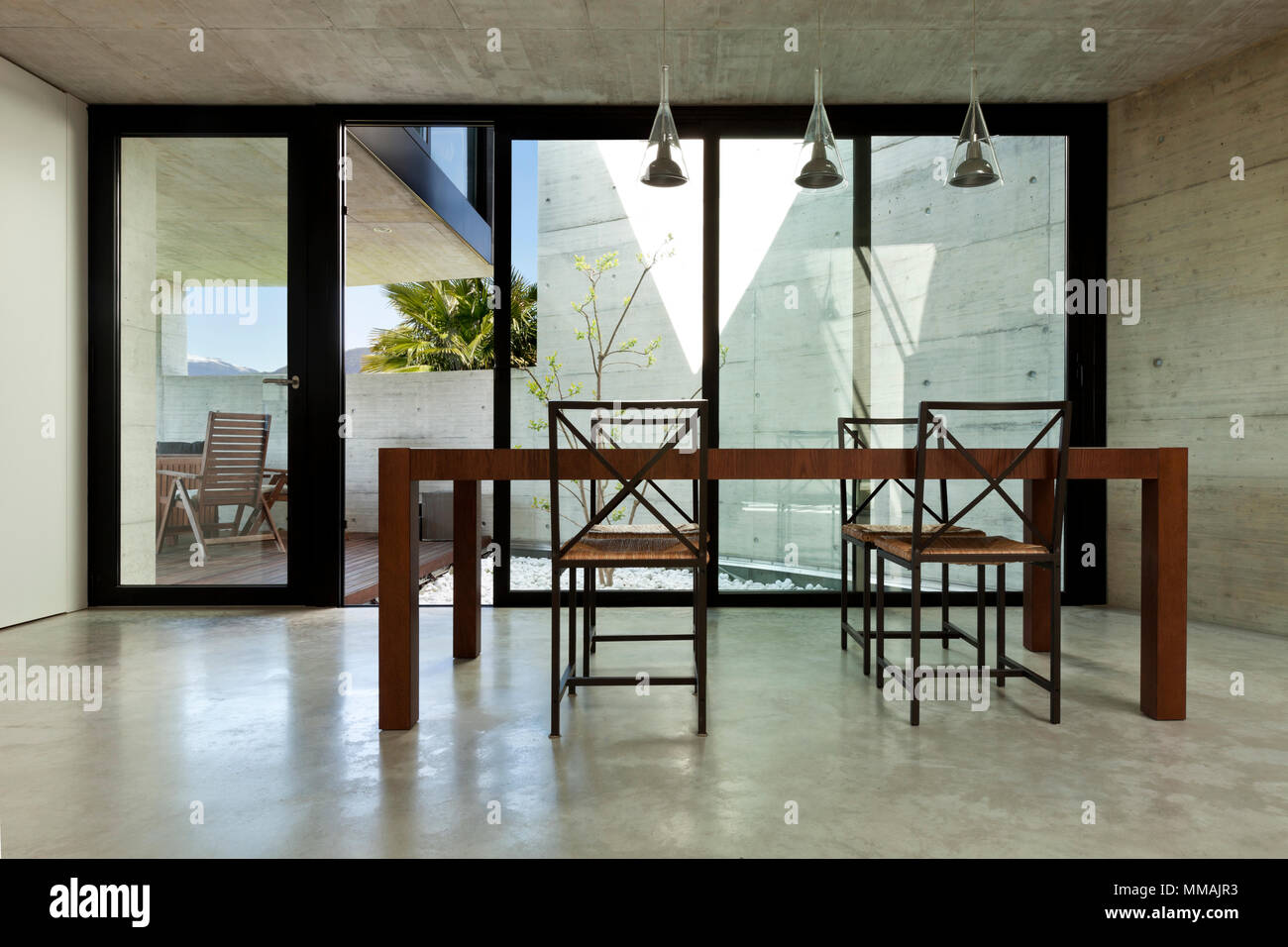 beautiful modern house in cement, interior, wooden dining table Stock ...