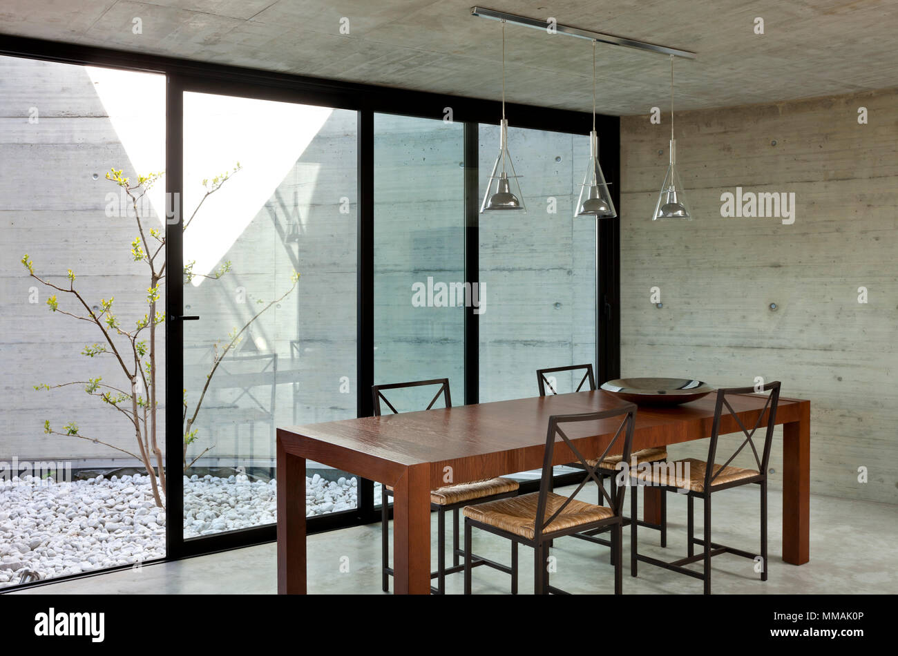 beautiful modern house in cement, interior, wooden dining table Stock ...