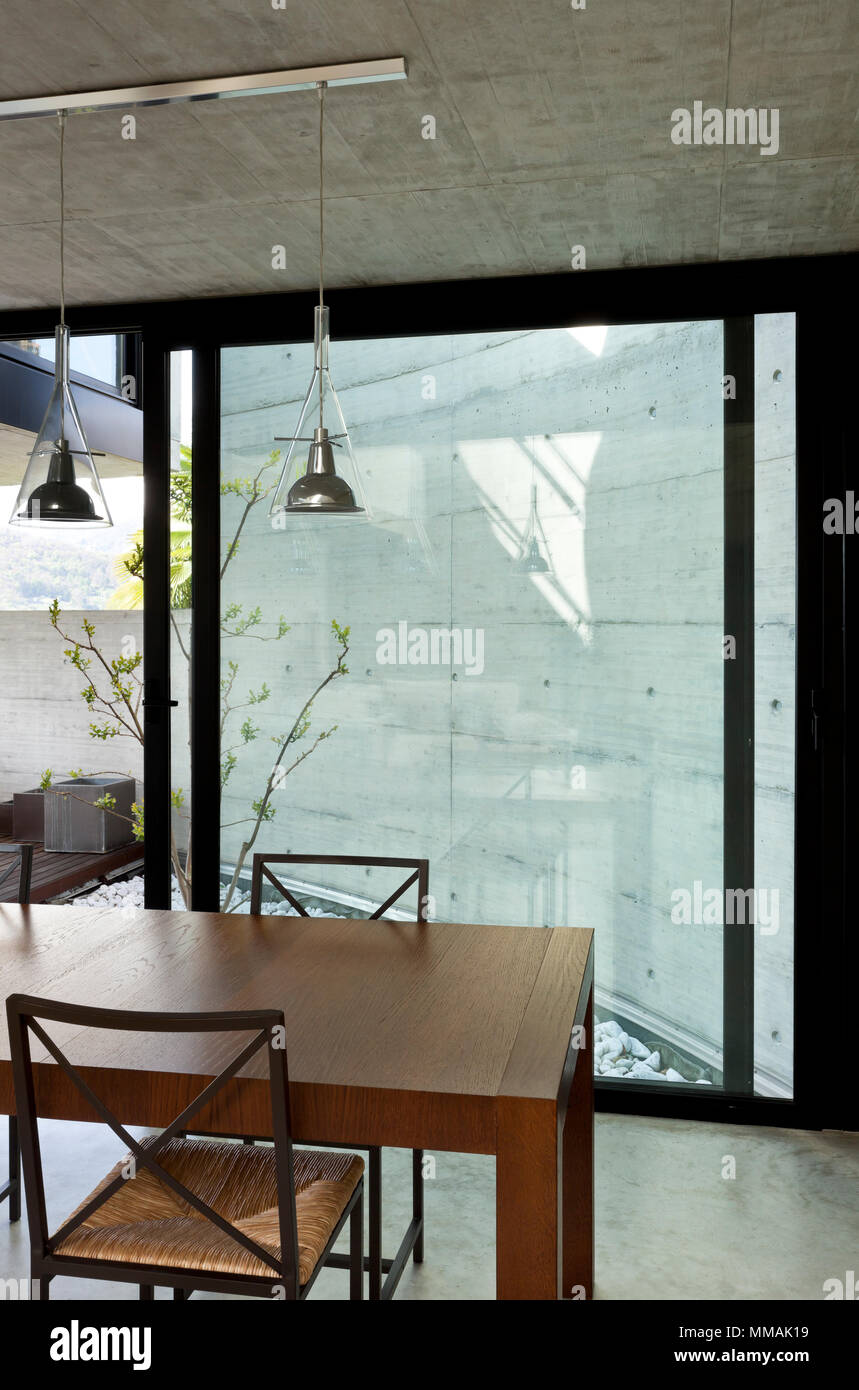 beautiful modern house in cement, interior, wooden dining table Stock ...