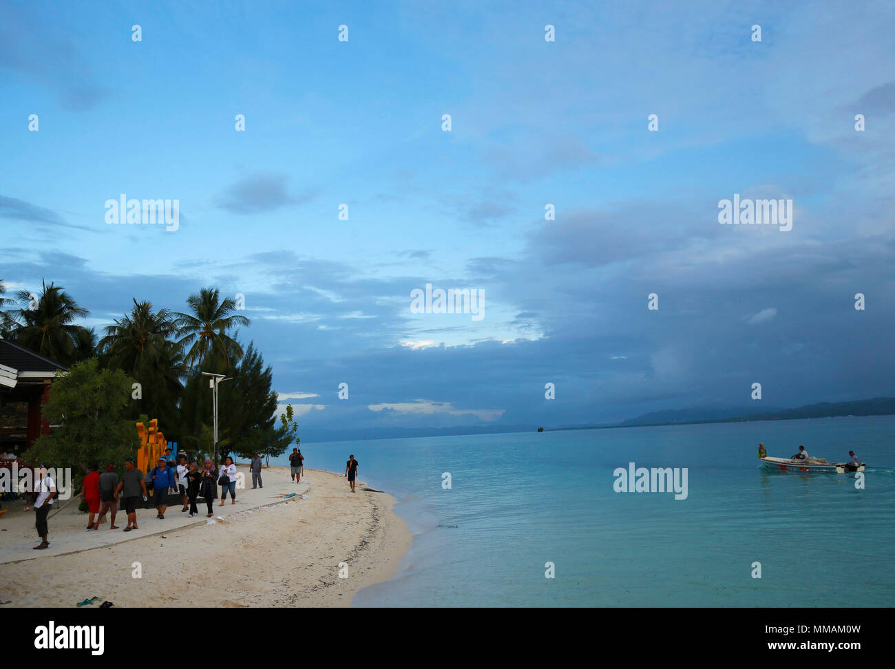 Visitors playing at Bokori Island, Kendari, South East Sulawesi ...