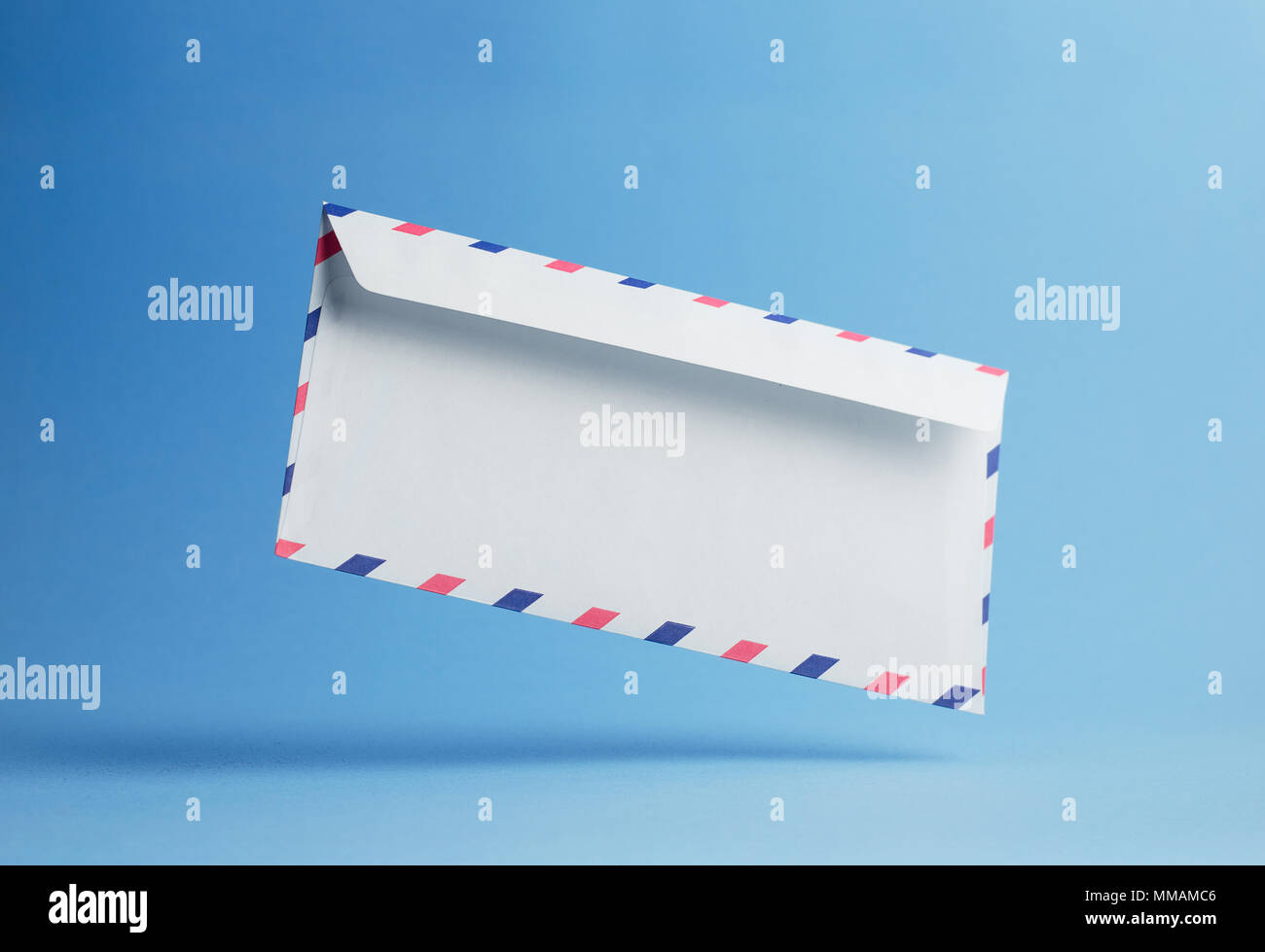 Envelope falling on the ground, blue background Stock Photo - Alamy