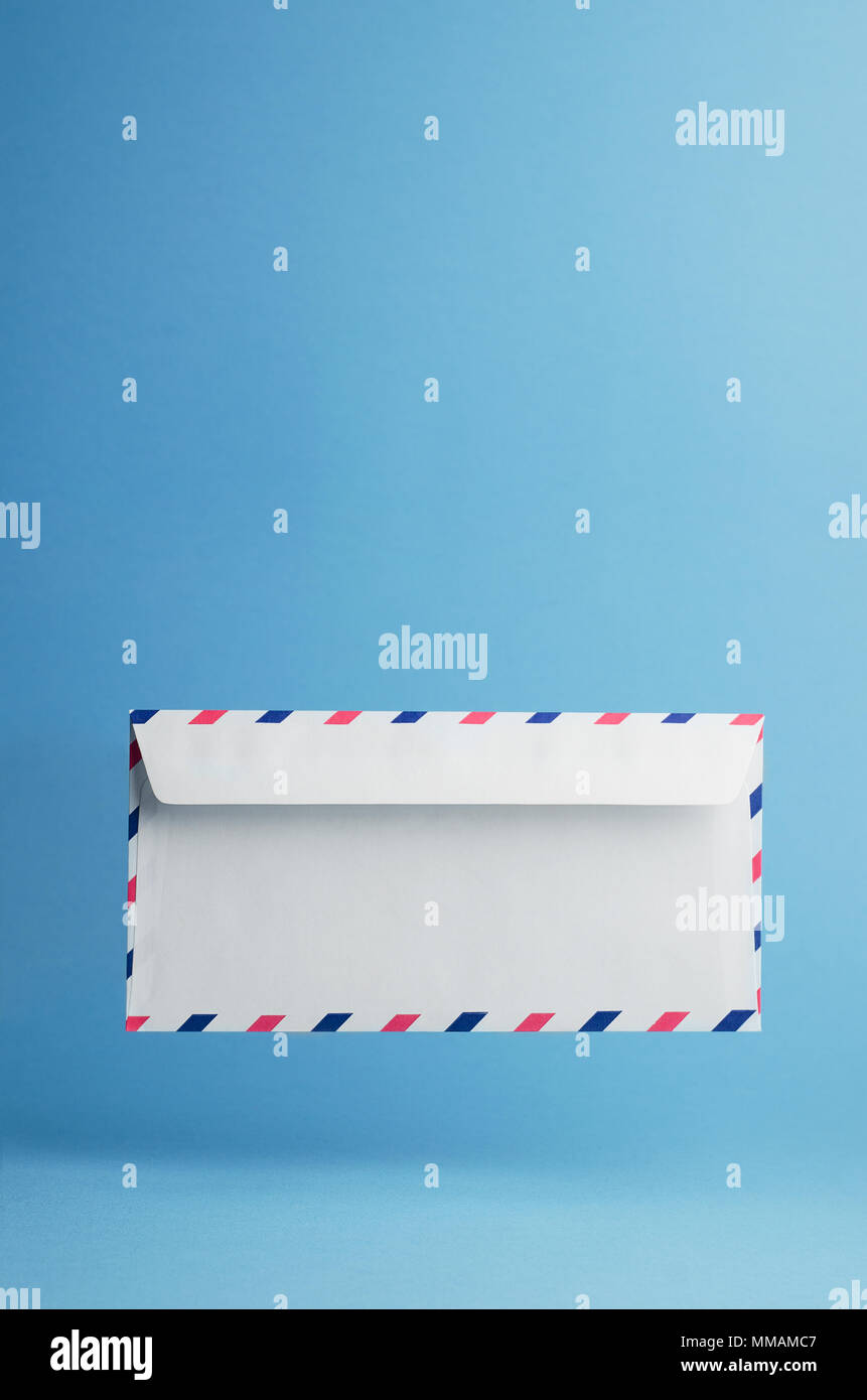 Envelope falling on the ground, blue background with negative space ...