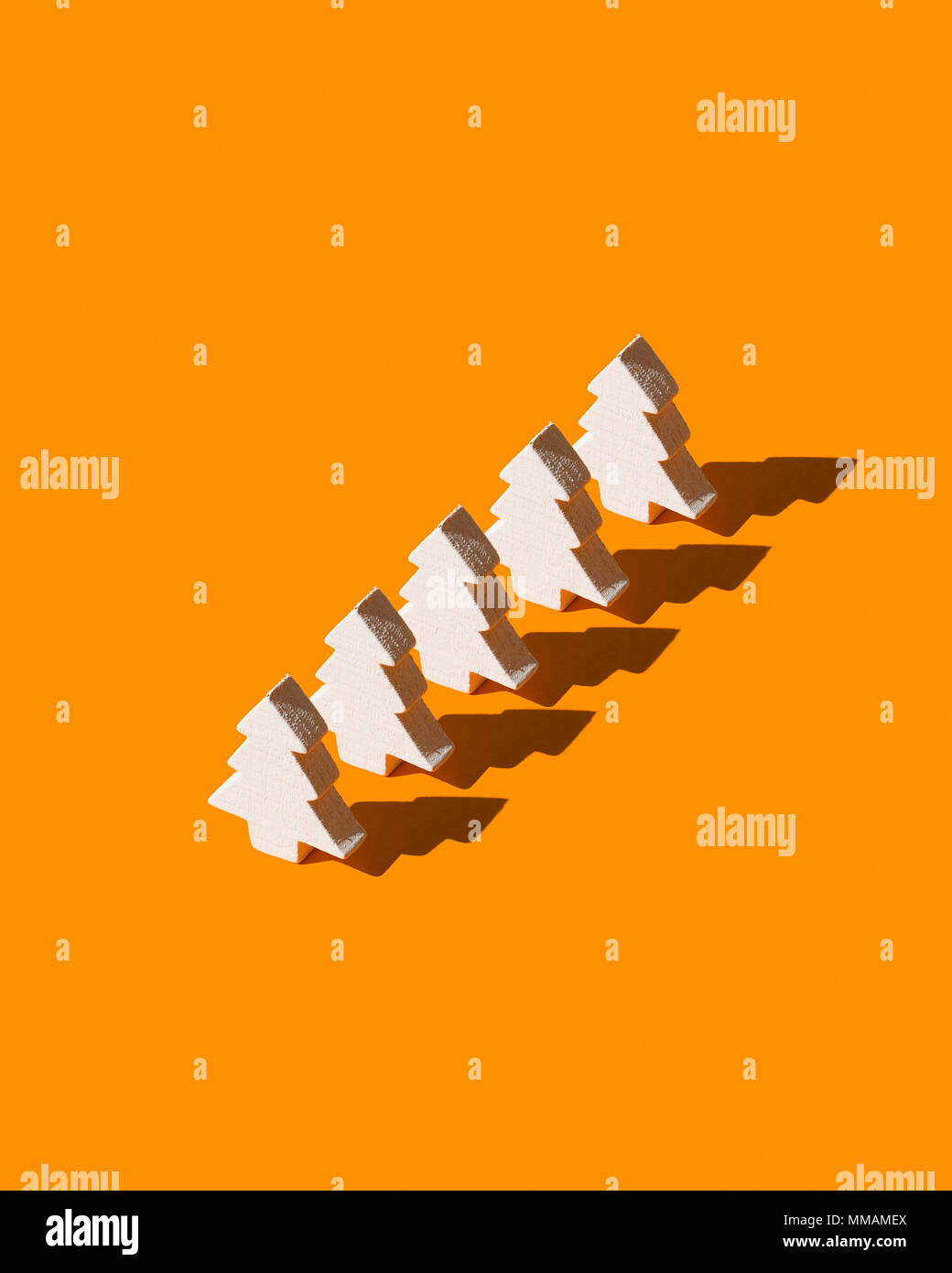 Decorative white trees organized in a row over orange background Stock ...