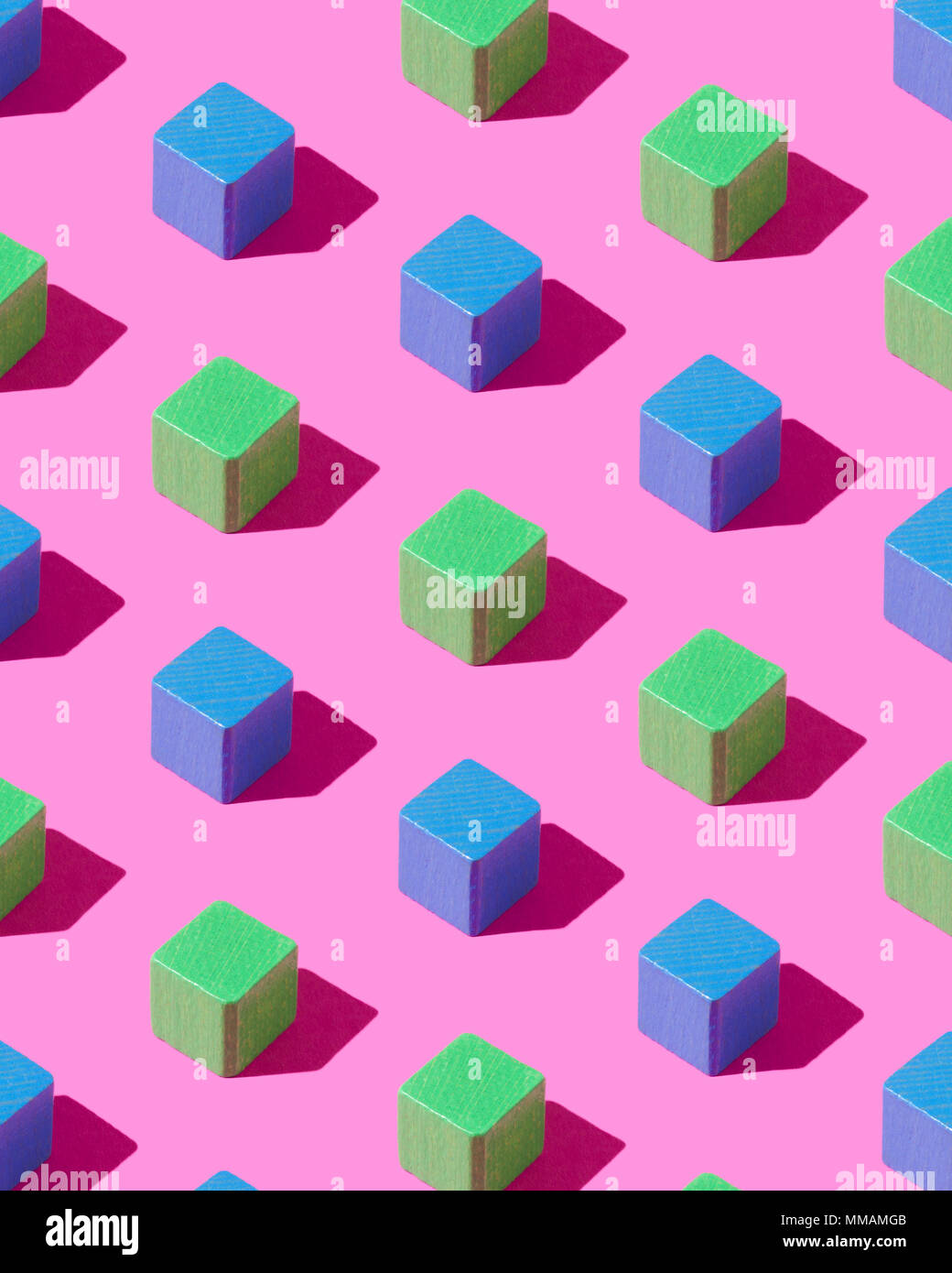Blue and green wooden cubes organized over pink background Stock Photo ...