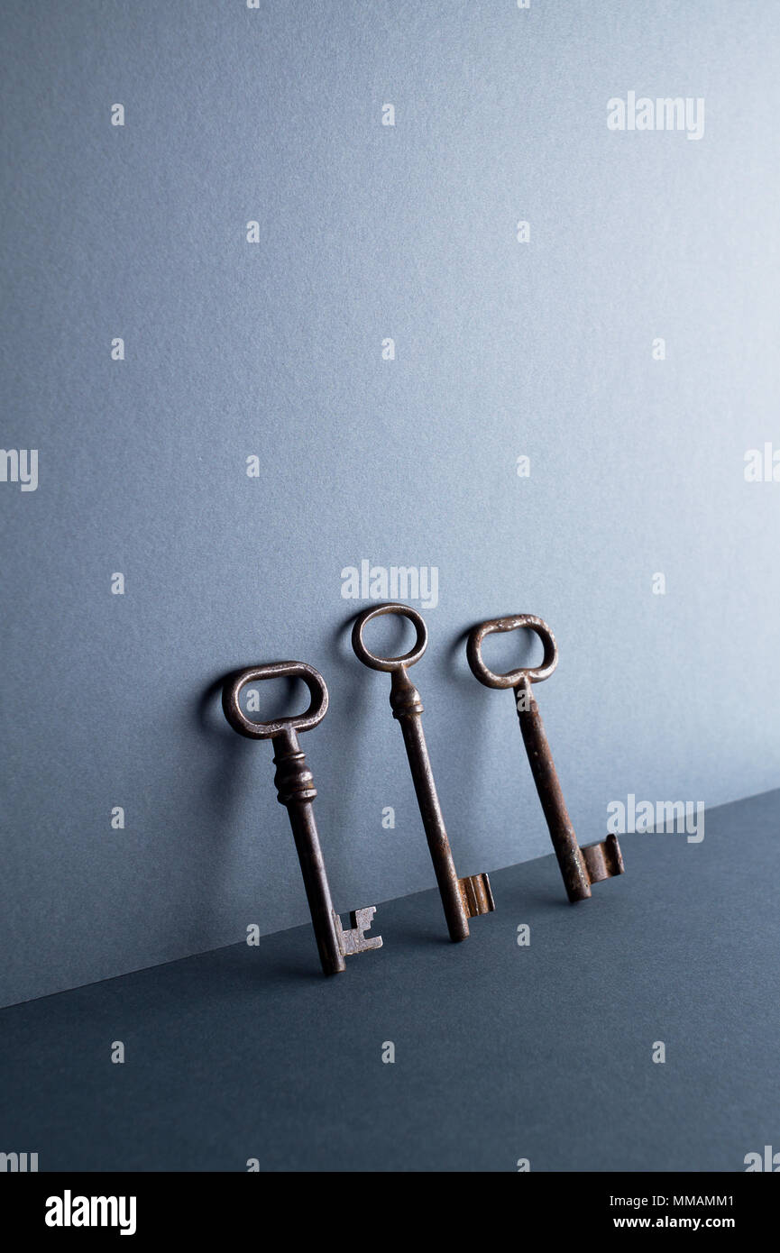 Vintage Keys leaning against dark blue background with negative space ...
