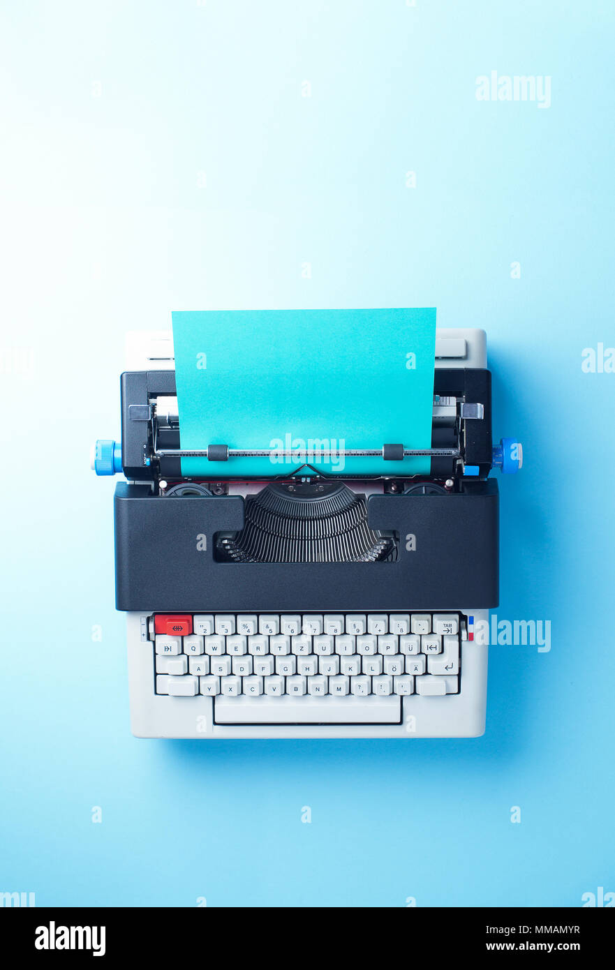 Typewriter with blue paper over blue background, top view Stock Photo ...