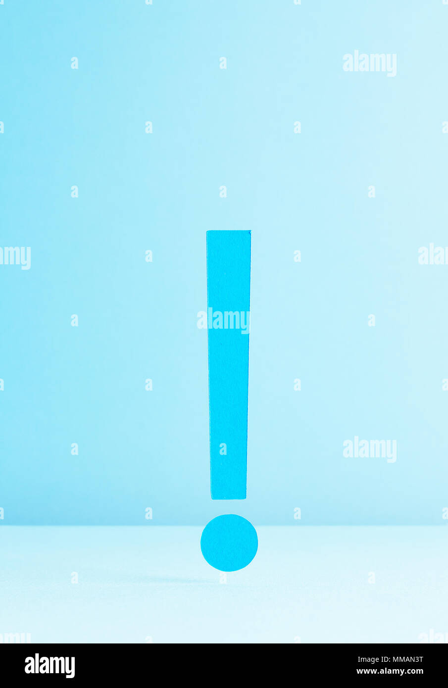 Exclamation point over blue background Stock Photo - Alamy