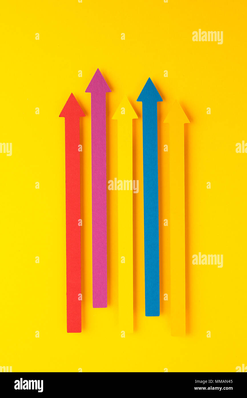 Arrows pointing forward over yellow background Stock Photo - Alamy