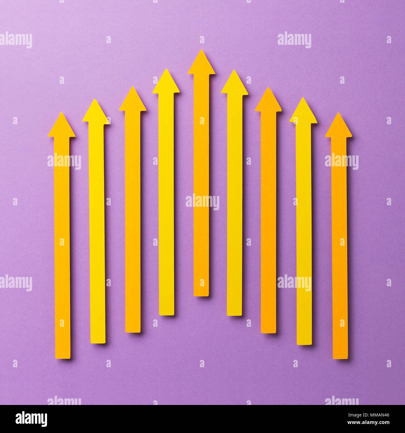 Yellow arrows over purple background Stock Photo - Alamy