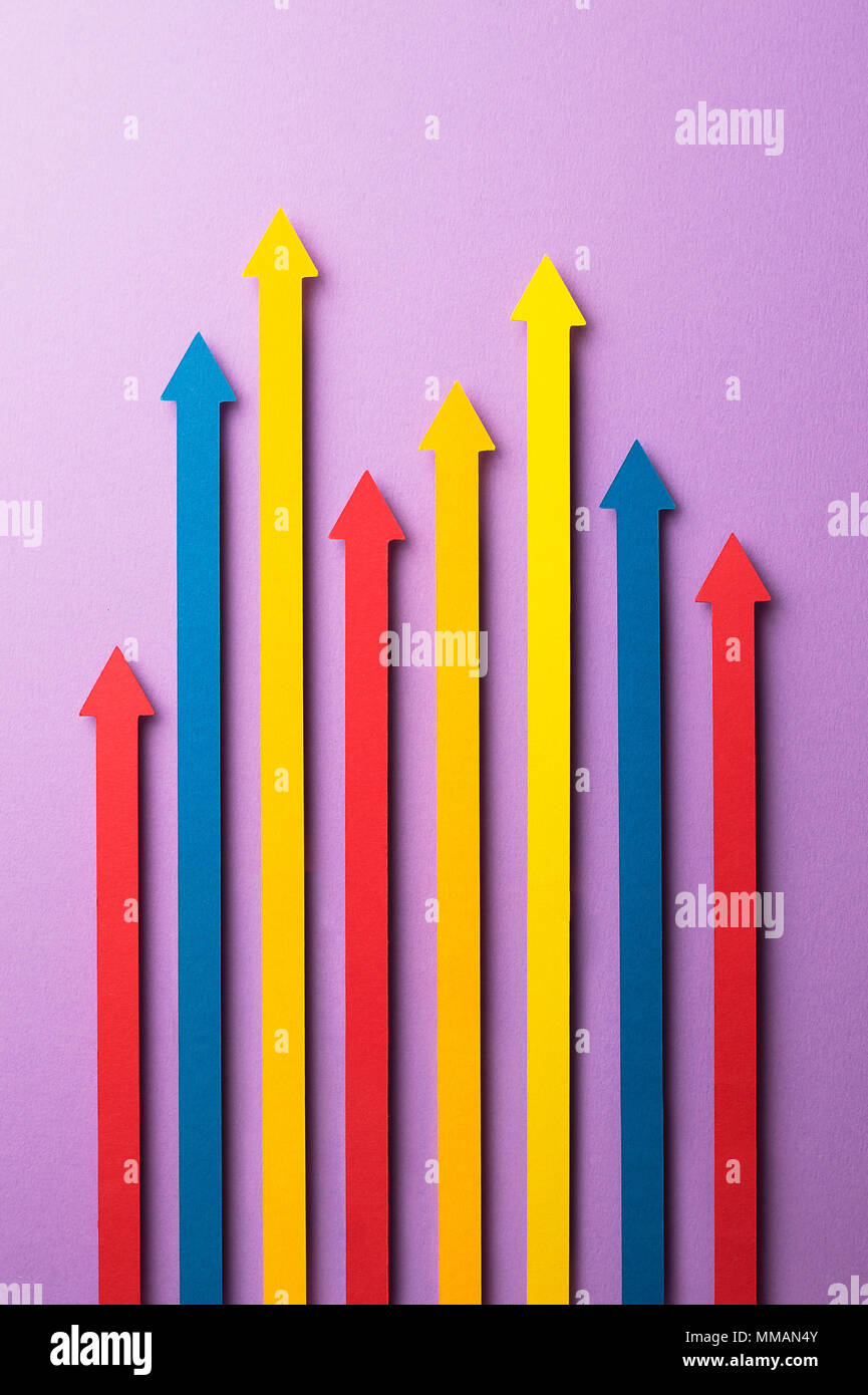 Arrows pointing forward over purple background Stock Photo - Alamy