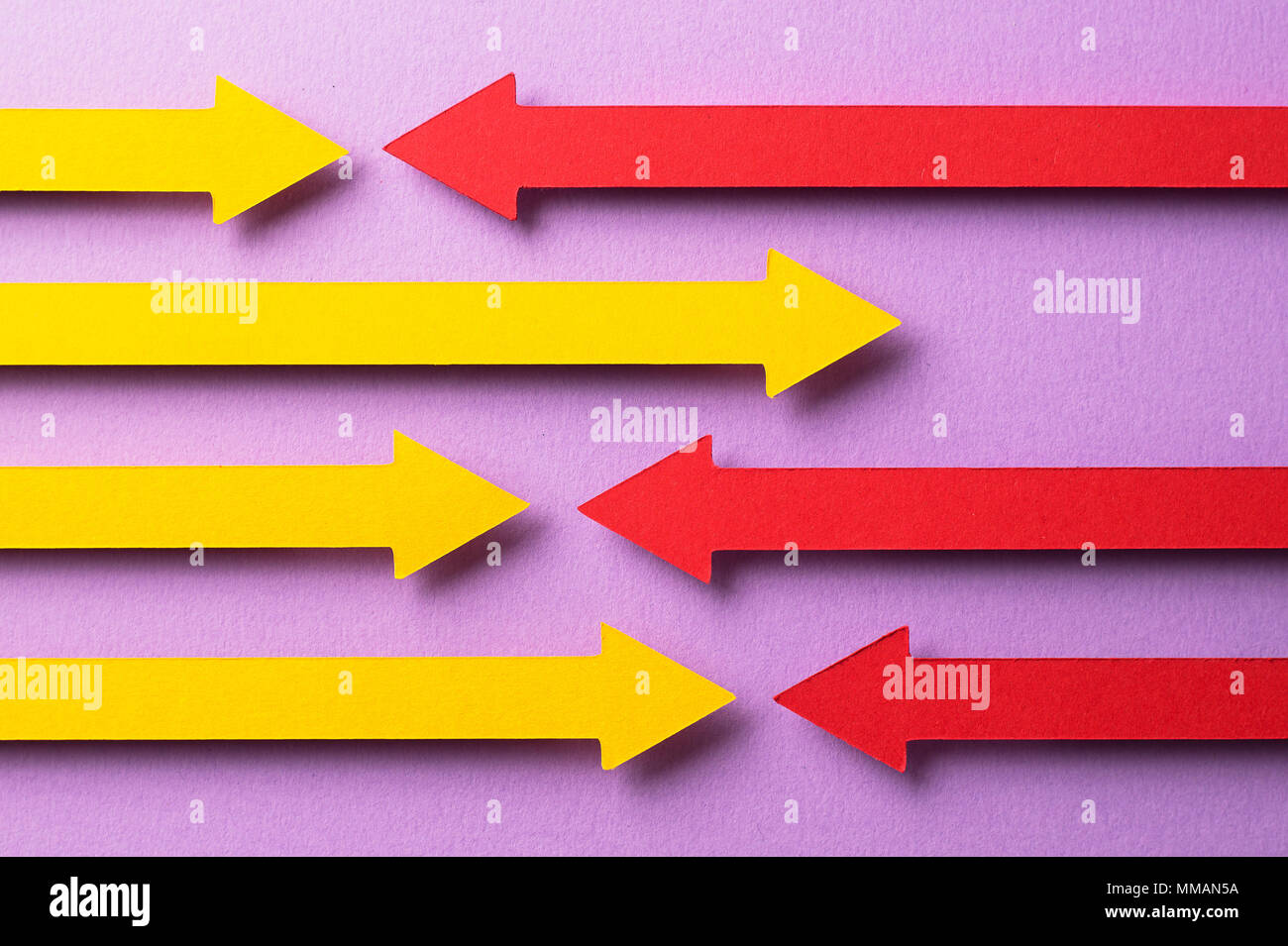 Red and yellow arrows over purple background Stock Photo - Alamy