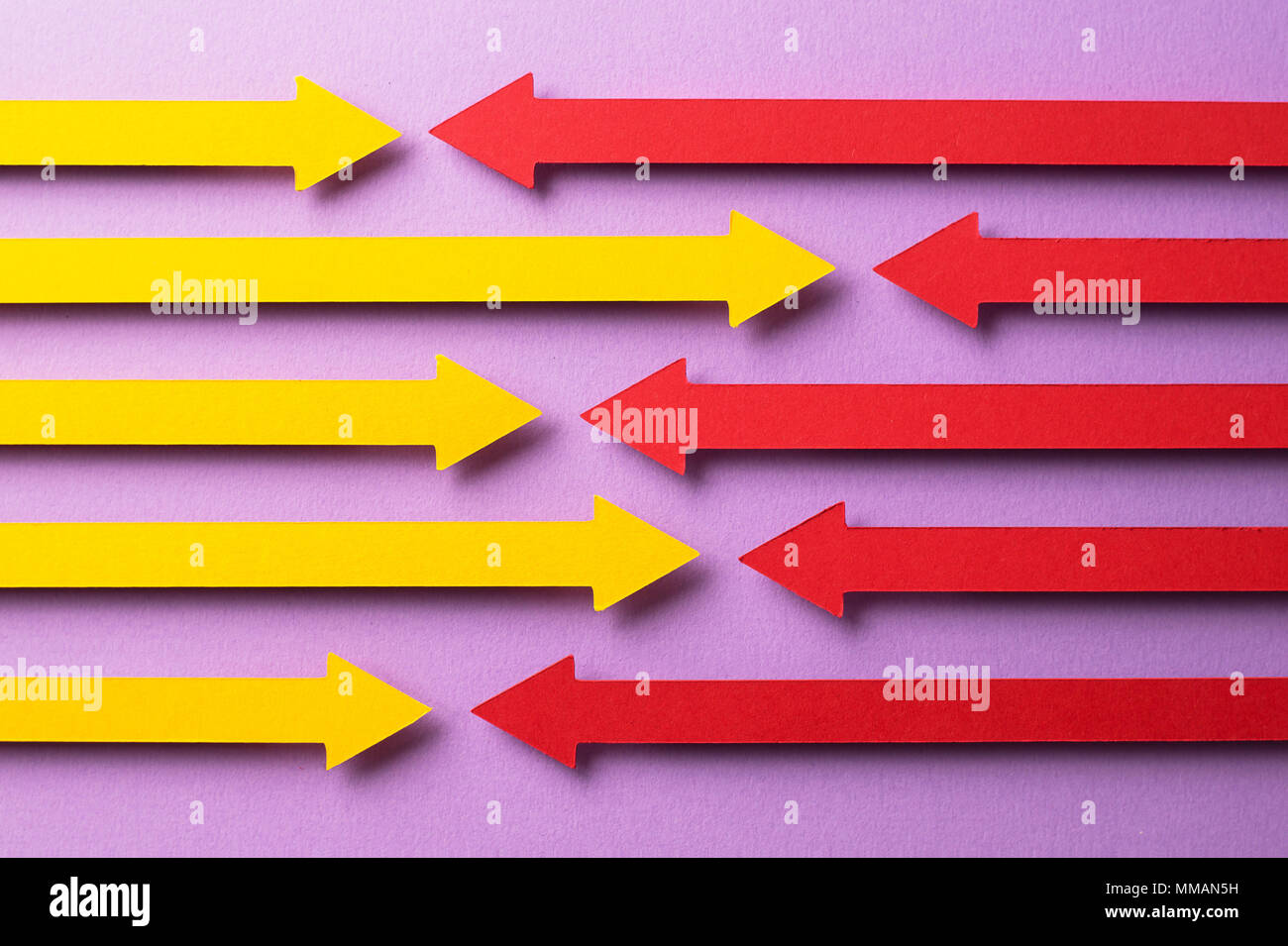 Red and yellow arrows over purple background Stock Photo - Alamy