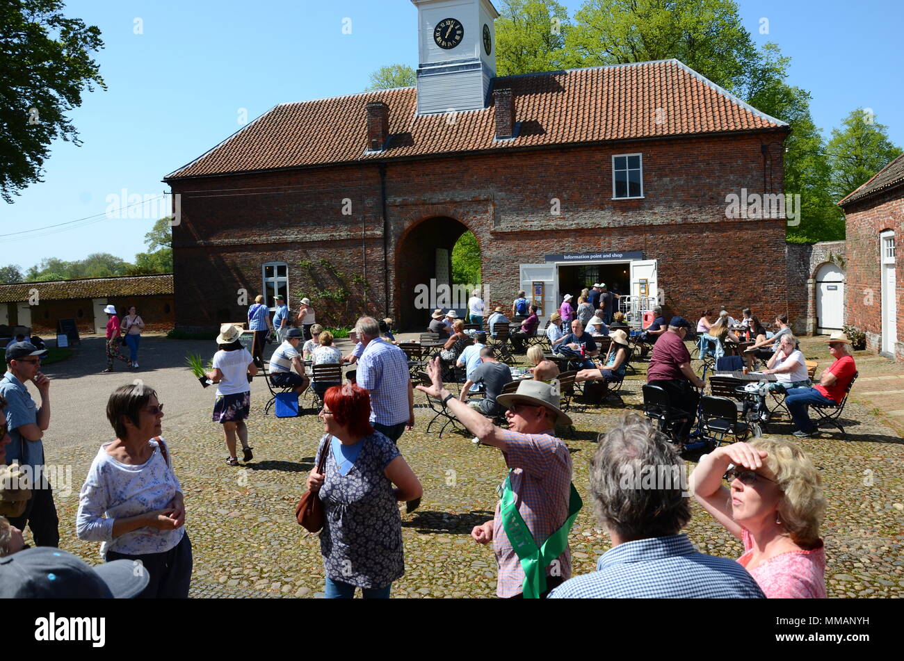 Visitors have tea and cakes in the sunshine in the courtyard of Gunby ...