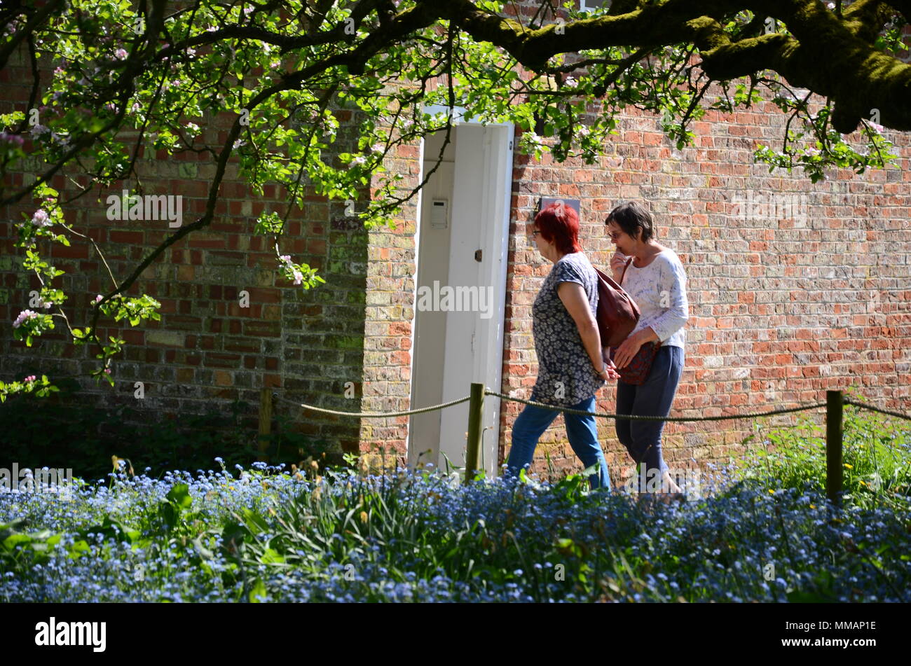 Visitors touring the gardens at Gunby Hall in Spring, Lincolnshire, UK ...