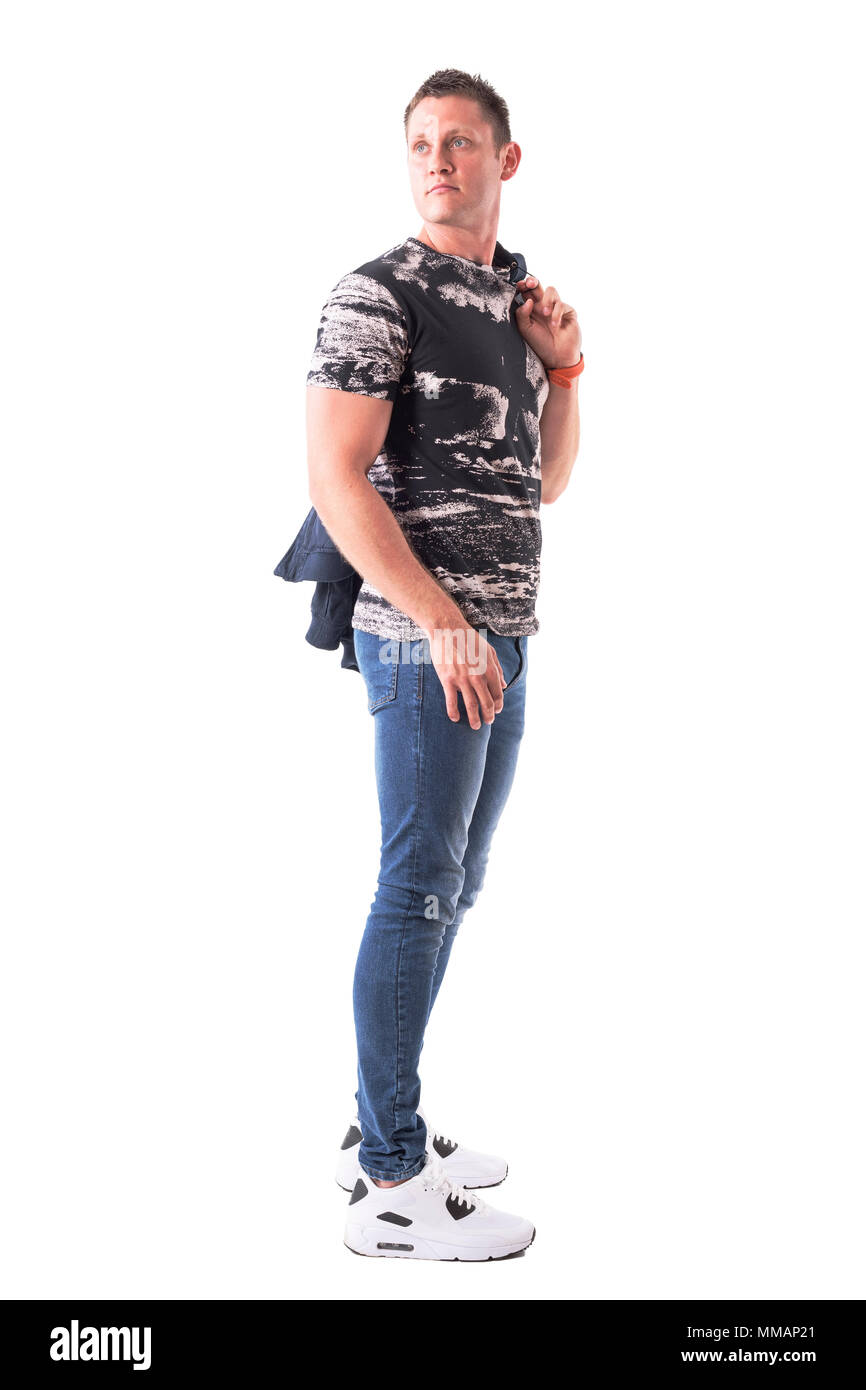 Side view of young adult confident man carrying jacket over shoulder ...