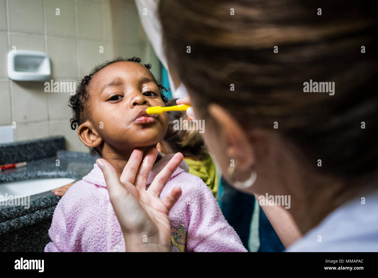 South american girl brushing his teeth hi-res stock photography and ...