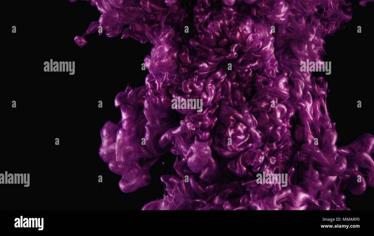 Ink in water. Colour pink glitter paint reacting in water creating ...