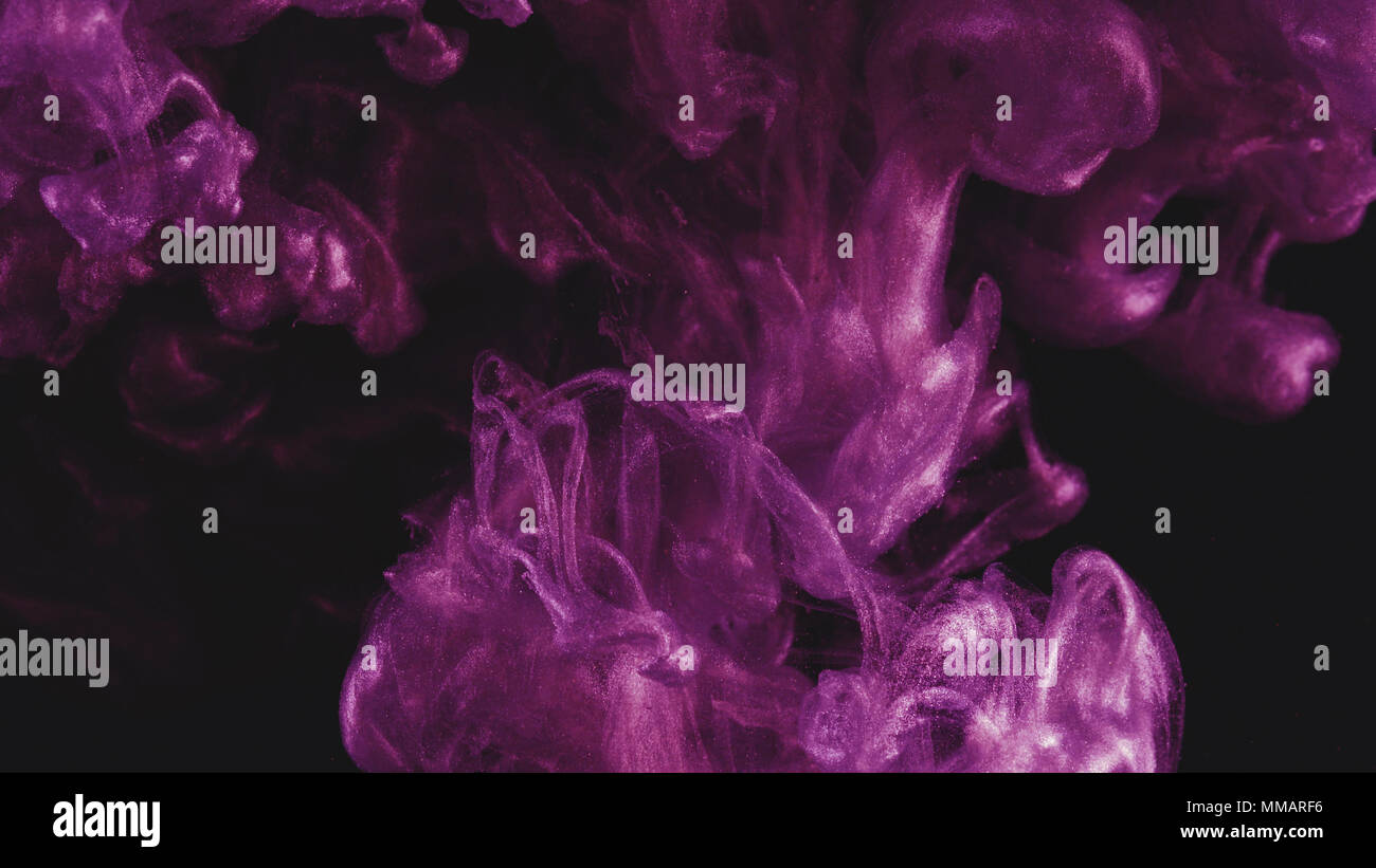 Ink in water. Colour pink glitter paint reacting in water creating ...