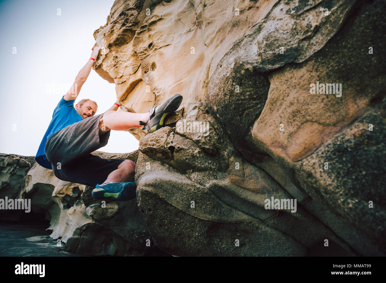 Man hanging on cliff hi-res stock photography and images - Alamy