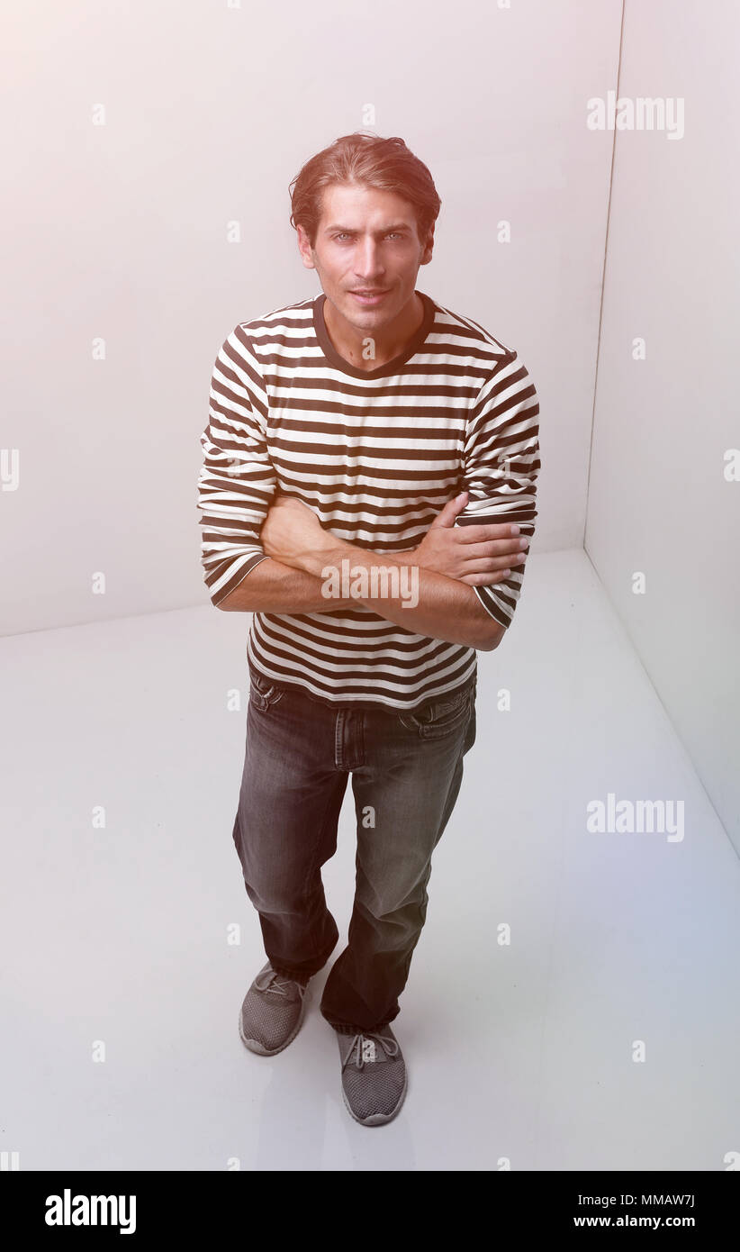 modern man standing in the corner of the white room Stock Photo - Alamy