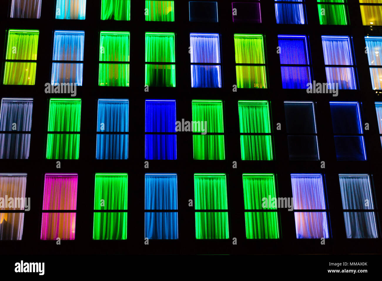 Colored windows texture. Windows illuminated by neon lights background ...