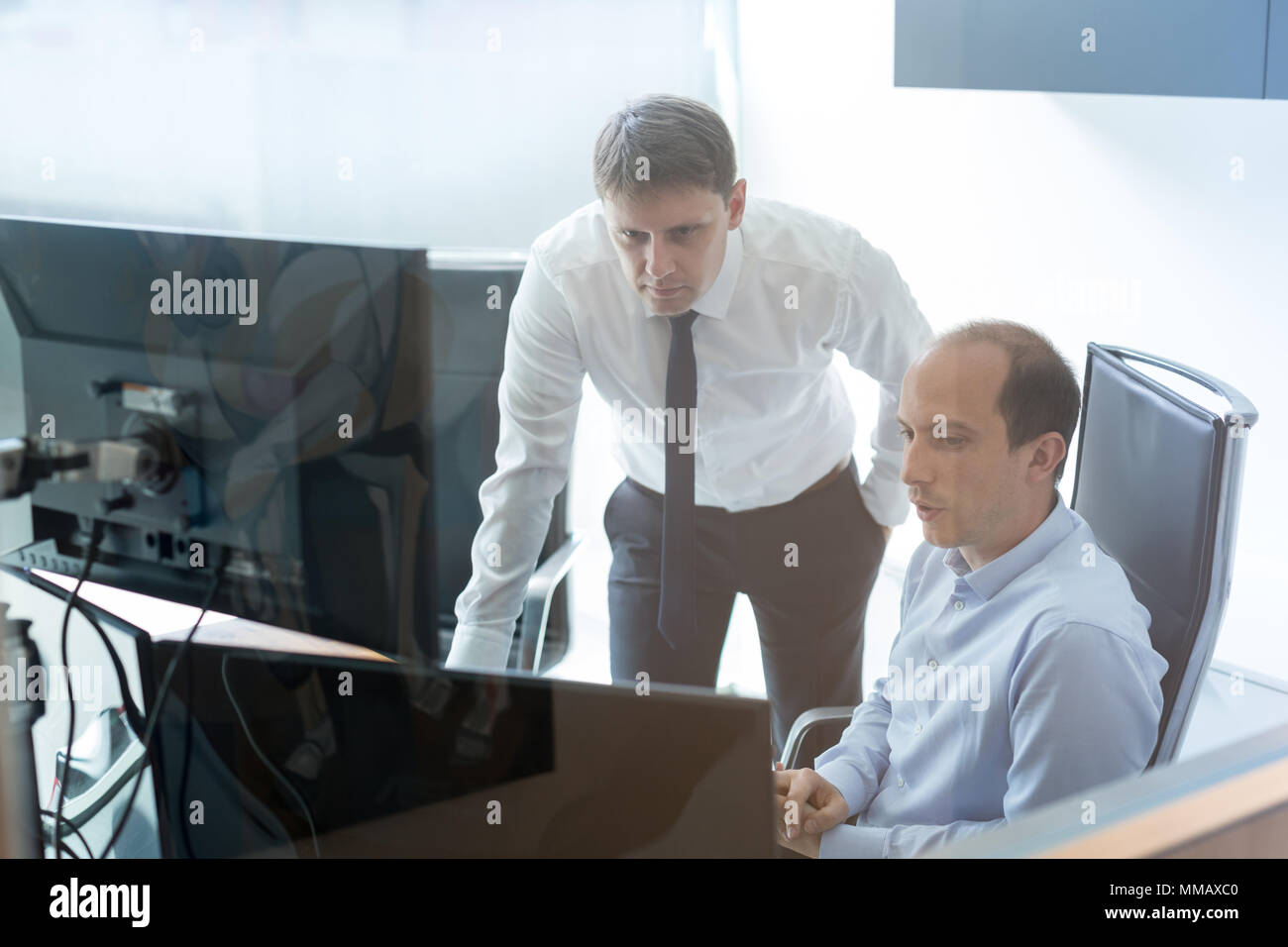Man at two computer screens hi-res stock photography and images - Alamy
