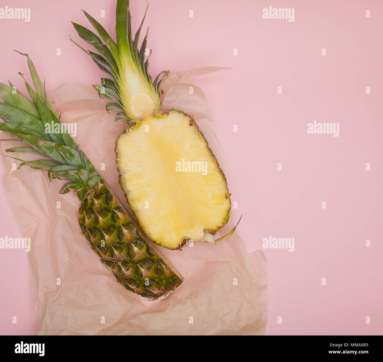 Half cut juicy pineapple on a pastel pink background. Minimal summer ...