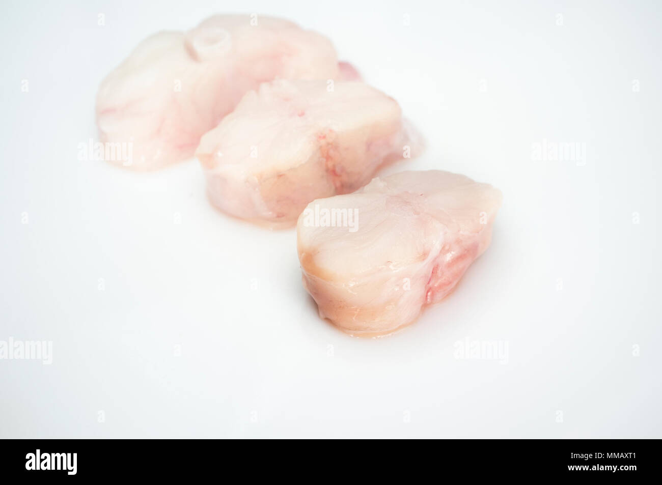 Monkfish tail steaks. Isolated over white background. Isolated over ...