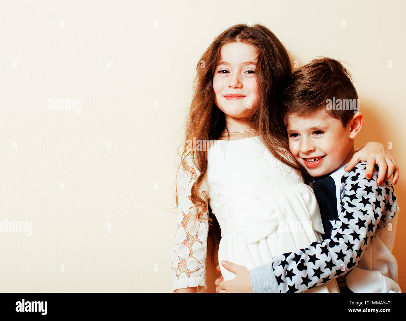 little cute boy and girl hugging playing on white background, ha Stock Photo - Alamy