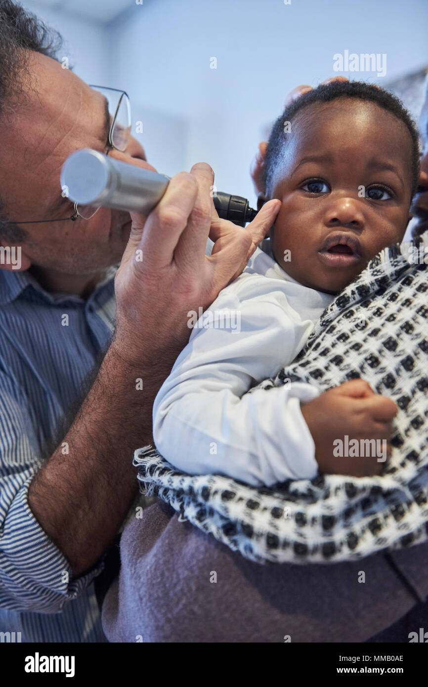 Nose and throat examination otoscope pediatrics hi-res stock ...