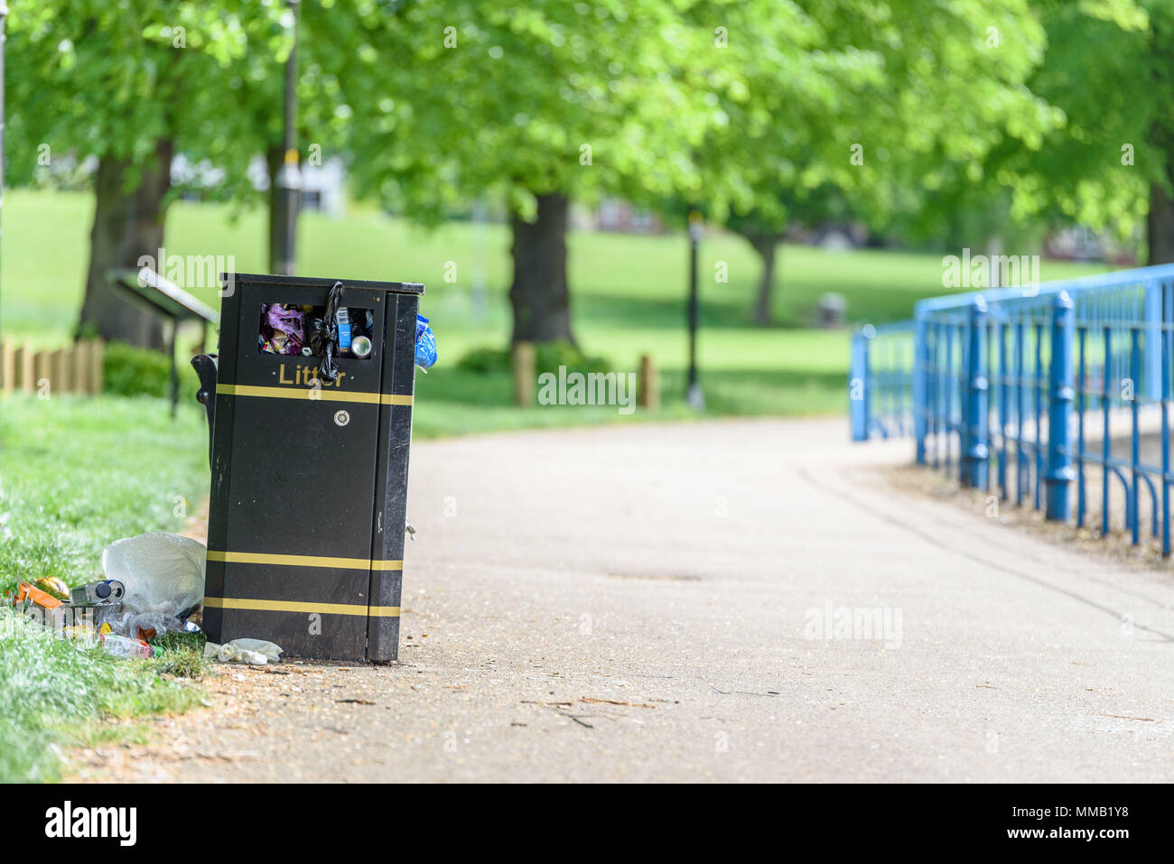 Day view overcrowded overfilled with rubbish black metal trash litter ...