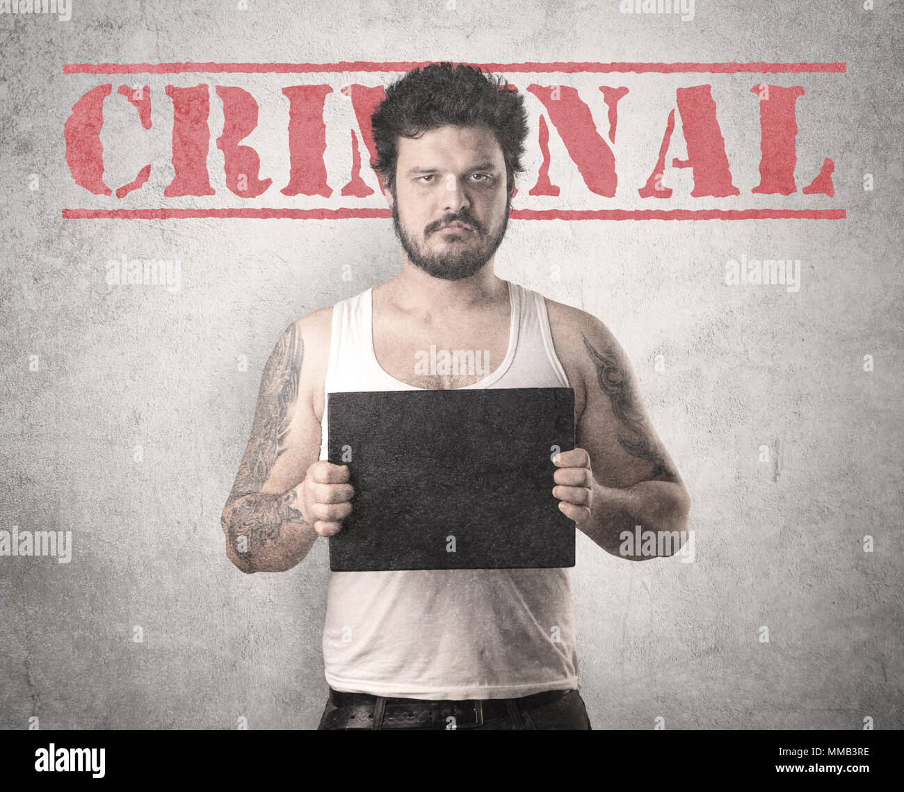 Caught gangster with criminal background Stock Photo - Alamy