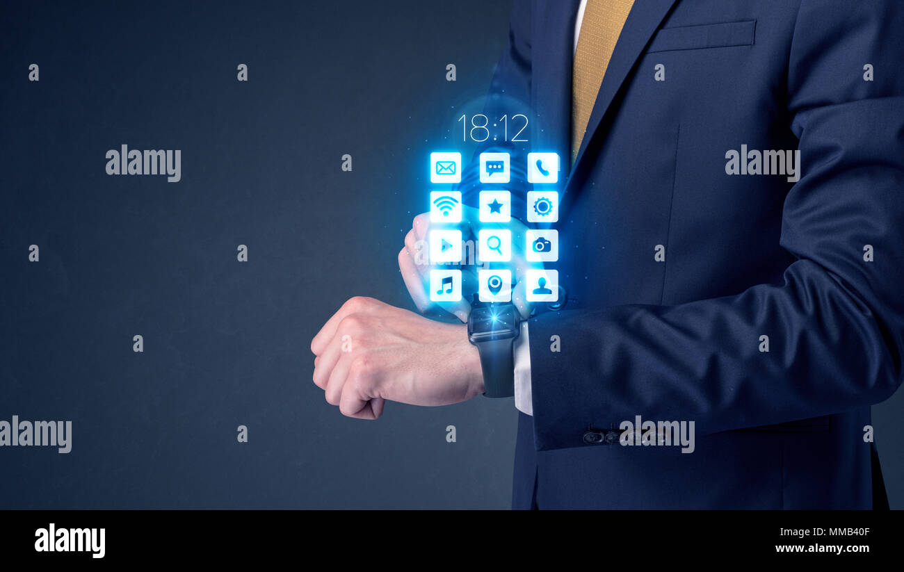 Businessman wearing smartwatch with application icons Stock Photo - Alamy