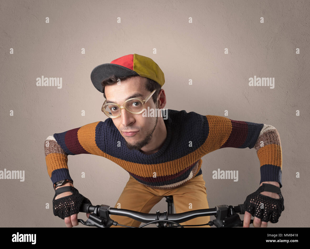 Nerd young foolish biker on a bike with oldschool outfit Stock Photo ...