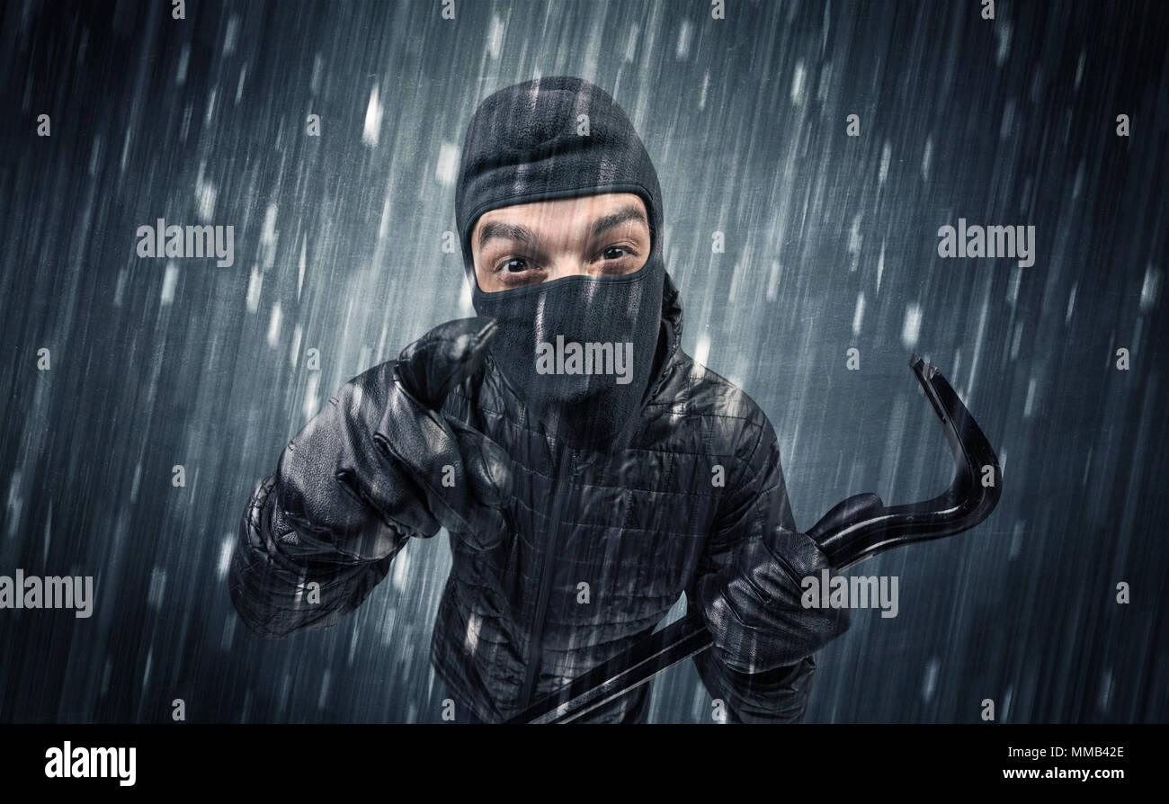 Burglar in action in black clothes with rainy concept Stock Photo - Alamy