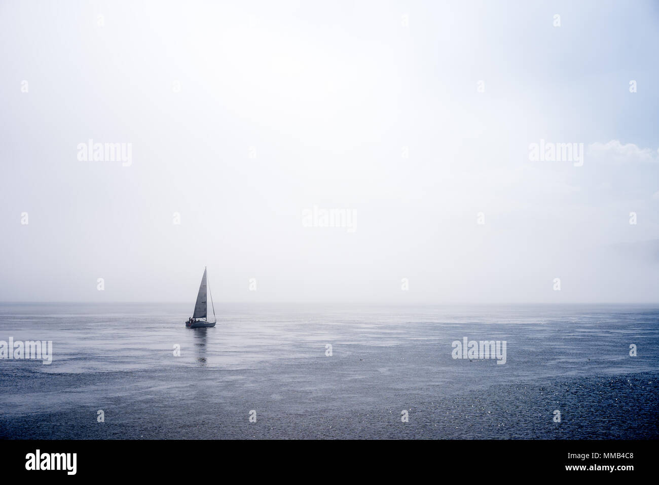 Lone sailing boat in Menai Strait near Anglesey North Wales Stock Photo ...