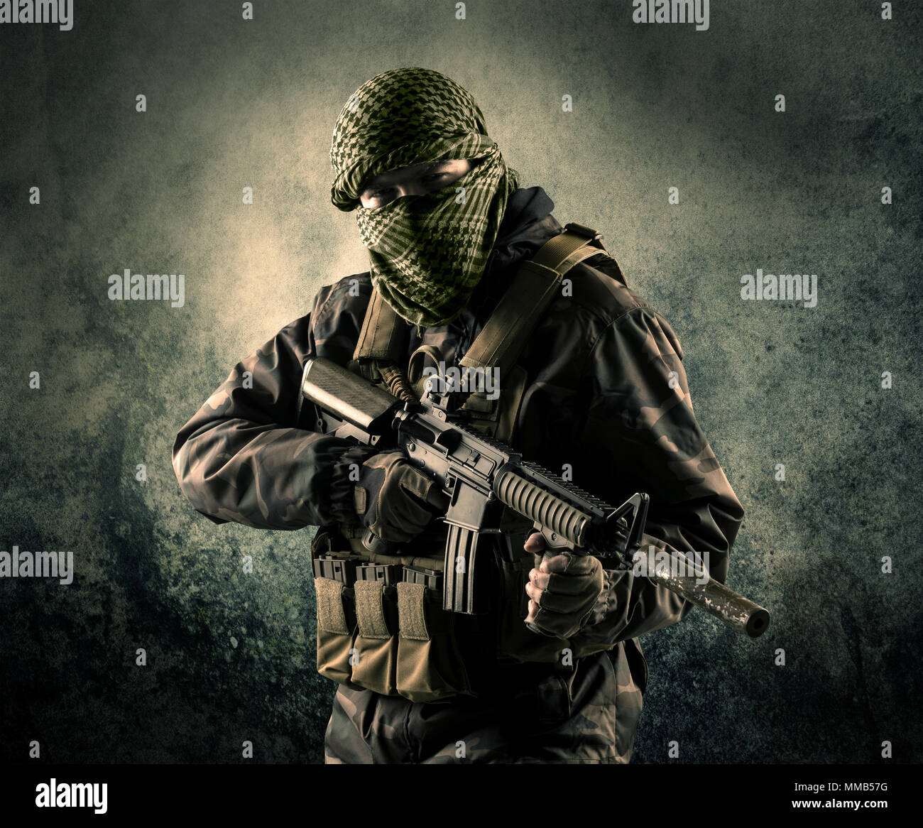 Portrait of a heavily armed masked soldier with grungy background ...