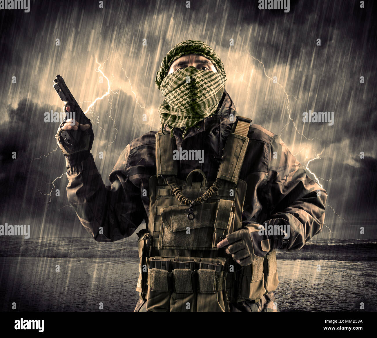 Portrait of a dangerous armed terrorist with mask and gun in a ...