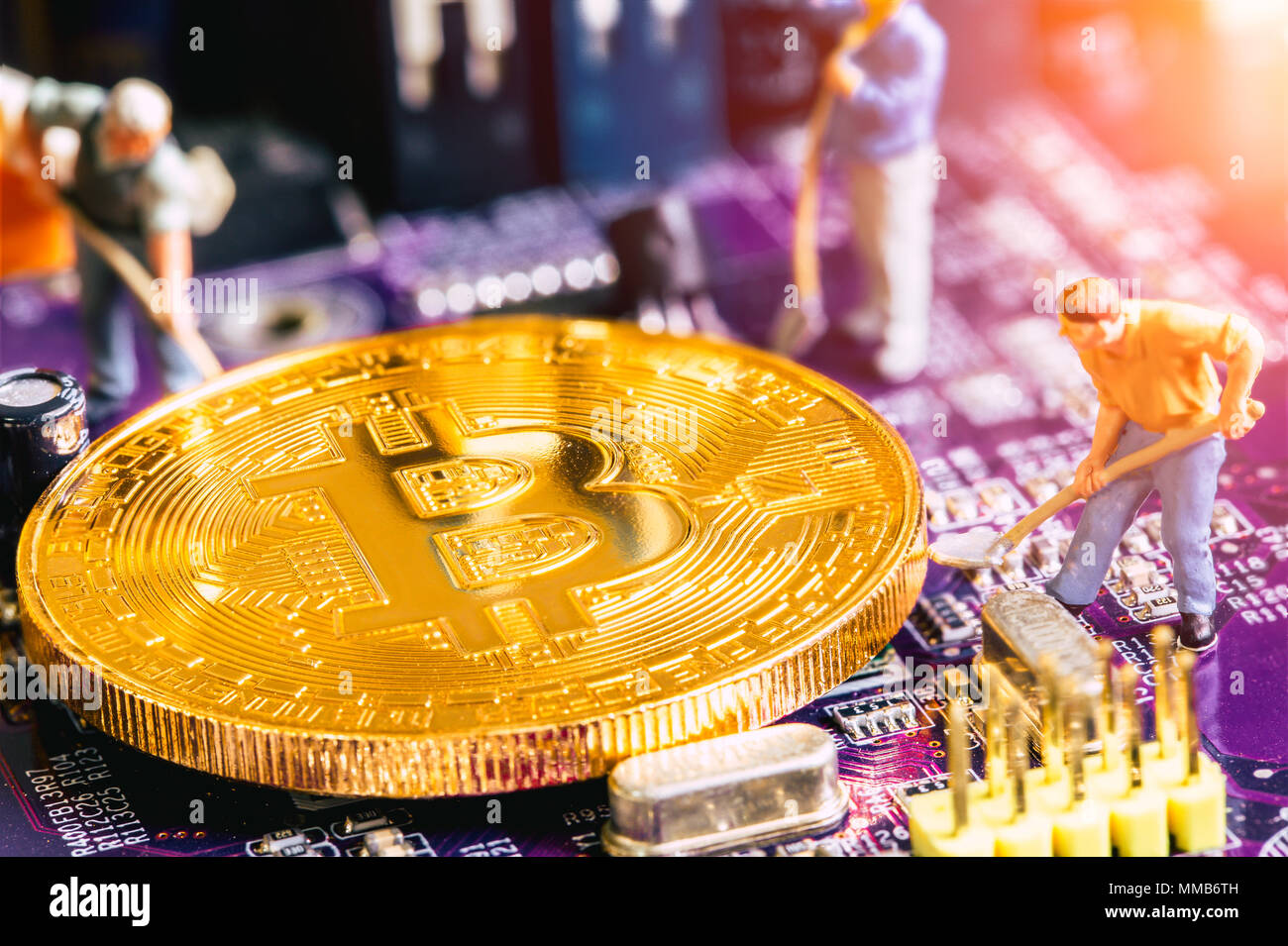 miniature worker dig gold bitcoin miner on electronic circuit board ...
