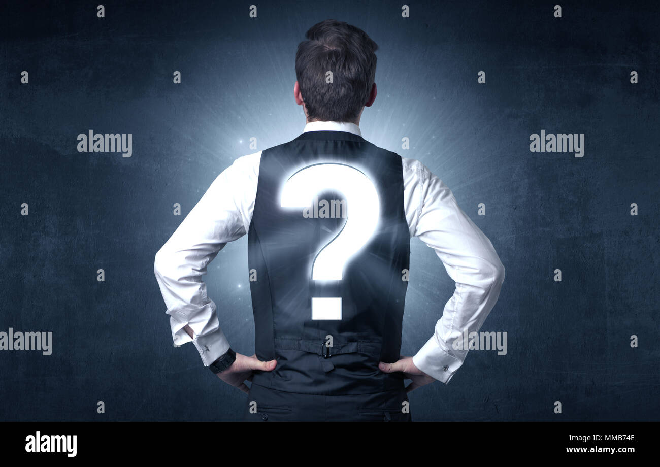 Businessman standing and thinking about questions Stock Photo - Alamy