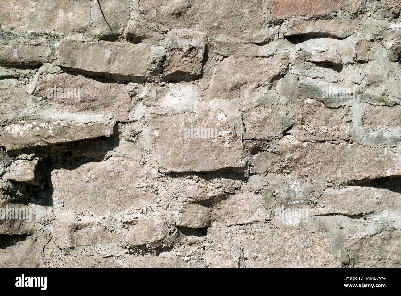 background, texture - rough masonry foundation of an ancient building ...